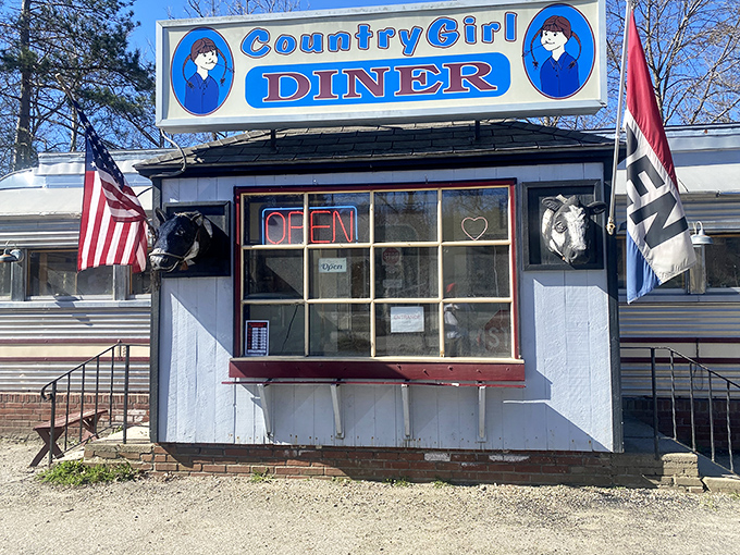 The classic silver diner car with its bright blue sign stands like a time capsule on Route 103, promising comfort food and conversations that matter.