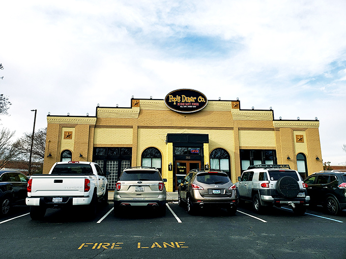 The sunshine-yellow exterior of Pop's Diner Co. stands out like a beacon for breakfast lovers, promising comfort food salvation with its cheerful "Kids Eat Free" sign.