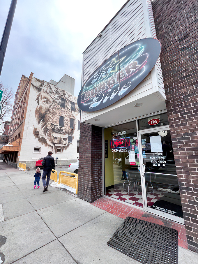 Step into burger paradise! The Burger Dive's retro neon sign beckons, while a majestic bison mural keeps watch. It's like a time-traveling foodie's dream come true.