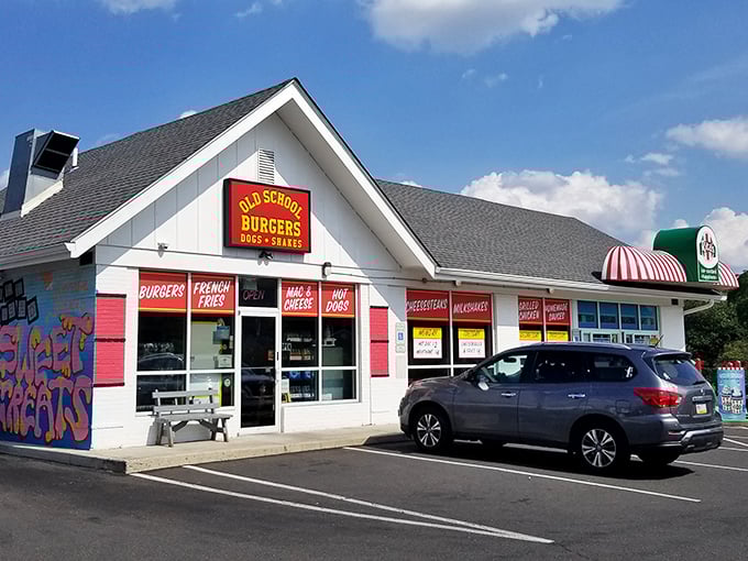 Welcome to burger paradise! Old School Burgers stands proud, its red shutters beckoning hungry travelers like a lighthouse for the famished.