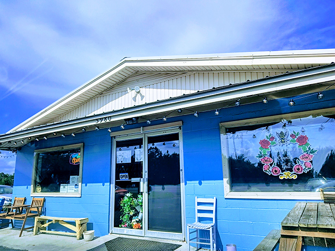 A blue beacon of breakfast bliss! Sweet Bee's Country Grill stands out against the sky, promising comfort food and small-town charm.