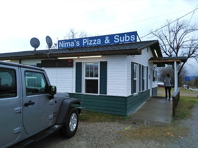 Welcome to Nima's, where the pizzas are hot and the frills are... well, let's just say they're as scarce as a snowball in July.