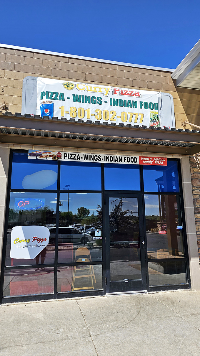 Welcome to flavor paradise! This unassuming storefront houses a culinary adventure where pizza meets curry in a delicious East-West fusion.