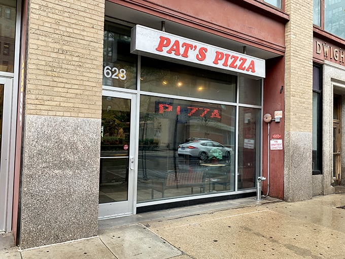 A slice of Americana! Pat's Pizza's unassuming storefront beckons with the promise of cheesy delights and a summer special that'll make your wallet as happy as your taste buds.