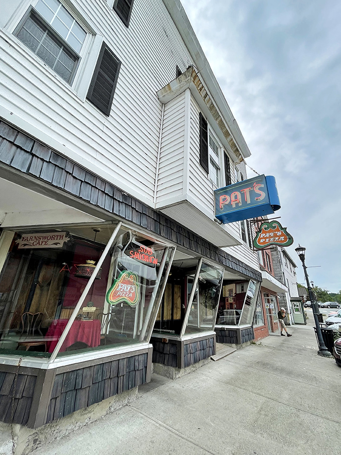 Welcome to pizza paradise! Pat's neon sign beckons like a lighthouse, guiding hungry souls to a haven of cheesy delights. 