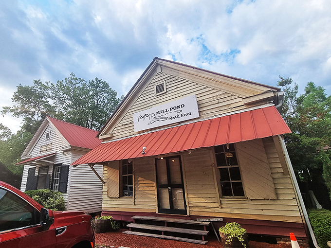 Welcome to Mill Pond Steakhouse, where the unassuming exterior hides a carnivore's paradise. It's like finding a diamond mine disguised as a cozy country cottage!