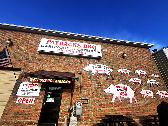 The unassuming brick exterior of Fatback's BBQ hides culinary treasures within. Those pig cutouts aren't just decoration&mdash;they're a roadmap to happiness.