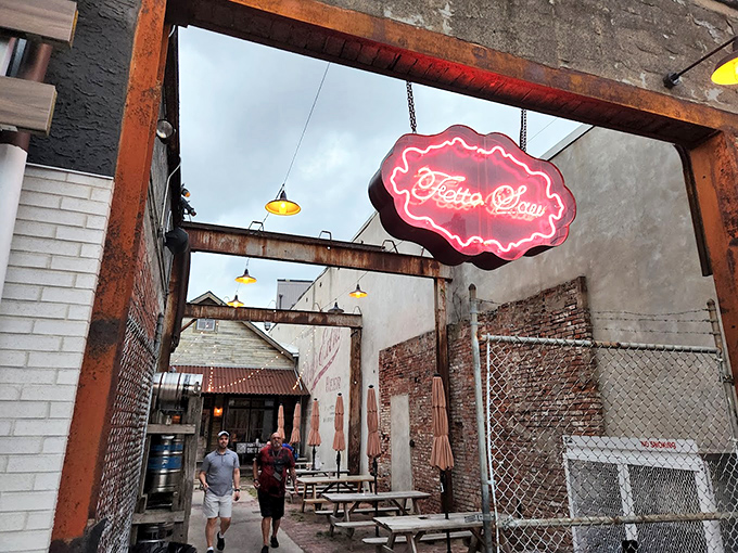 The entrance to meat paradise beckons with a glowing neon sign. This former auto body shop has found its true calling as a temple of smoke.