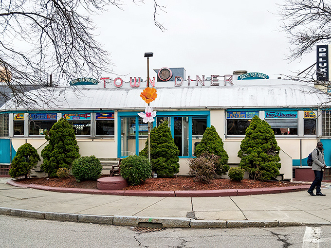 
The iconic curved roof and turquoise trim of Deluxe Town Diner stands as a beacon of breakfast hope on Mt. Auburn Street.