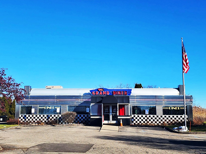The gleaming stainless steel exterior of The Grand Diner stands like a time machine to the golden age of roadside Americana. Those neon letters promise more than food&mdash;they promise nostalgia.