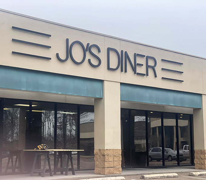 The classic facade of Jo's Diner in Flowood welcomes hungry patrons with its clean lines and retro signage&mdash;a beacon of breakfast bliss in Mississippi.