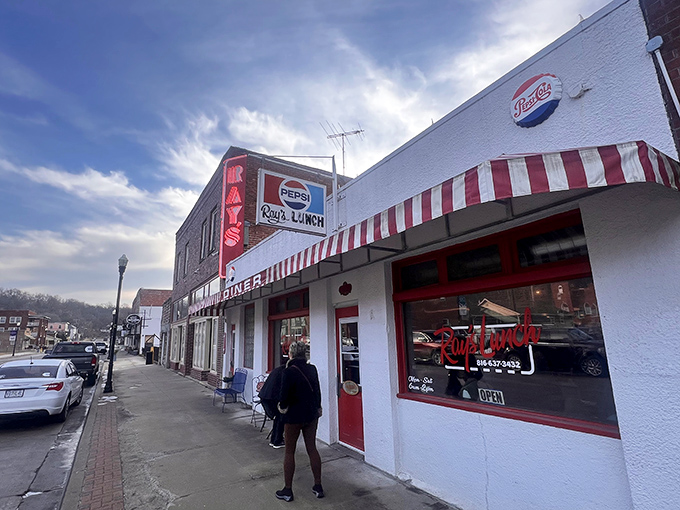 The classic white facade with red-striped awning isn't just inviting&mdash;it's practically a time machine to when breakfast cost less than your morning latte.
