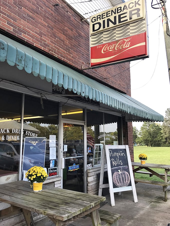 The classic brick exterior with its vintage Coca-Cola sign and green awning isn't trying to be retro-cool—it's the real deal, standing proudly since 1933.