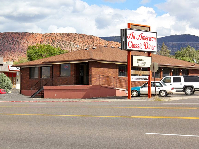 The classic roadside sign beckons like a lighthouse for hungry travelers. Against that perfect Utah blue sky, it promises comfort food salvation just off the highway.