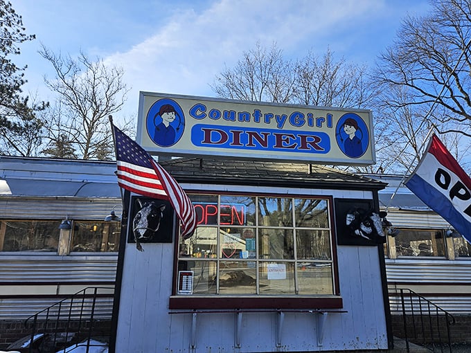 The classic silver diner car with its bright blue sign stands like a time capsule on Route 103, promising comfort food and conversations that matter.