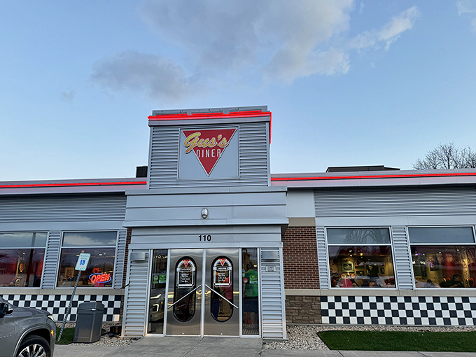 Welcome to flavor town! Gus's Diner stands proud, its red trim and checkered accents promising a feast for both eyes and stomach.