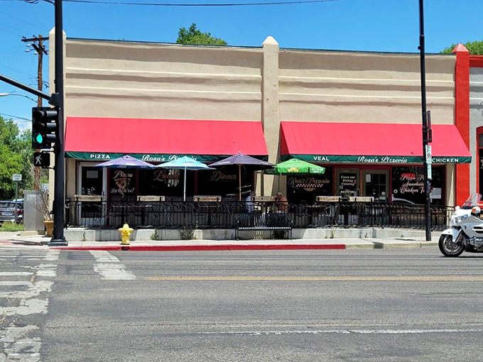 A slice of Italy on the streets of Prescott! Rosa's Pizzeria's vibrant red awning beckons like a siren song to hungry passersby.