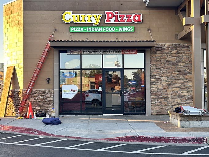 Welcome to flavor paradise! This unassuming storefront houses a culinary adventure where pizza meets curry in a delicious East-West fusion.