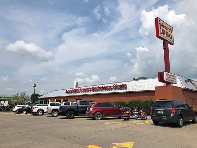 Welcome to flavor town! Jethro's BBQ 'n Jake's Smokehouse Steaks stands proud, its red-brick exterior promising a carnivore's paradise within. The aroma of slow-smoked meats practically wafts through the screen.