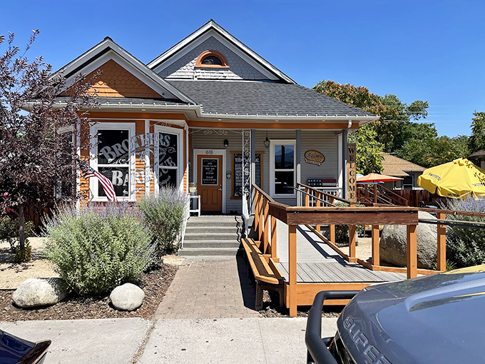 Home is where the smoke signals rise. Brothers Barbecue's charming cottage exterior with its bright orange accents promises comfort before you even step inside.