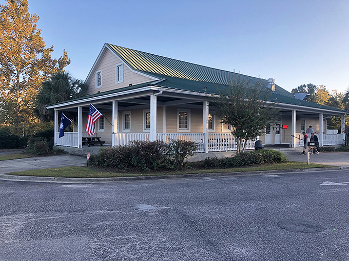 Home sweet smokehouse! This charming cottage-style exterior with its inviting porch says "grandma's cooking" before you even walk through the door.