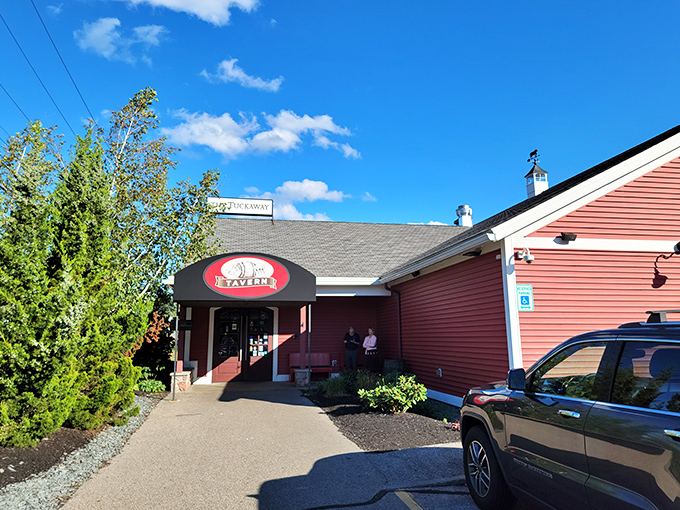 The crimson barn-like exterior of Tuckaway Tavern stands like a carnivore's lighthouse, beckoning hungry travelers with promises of protein perfection.