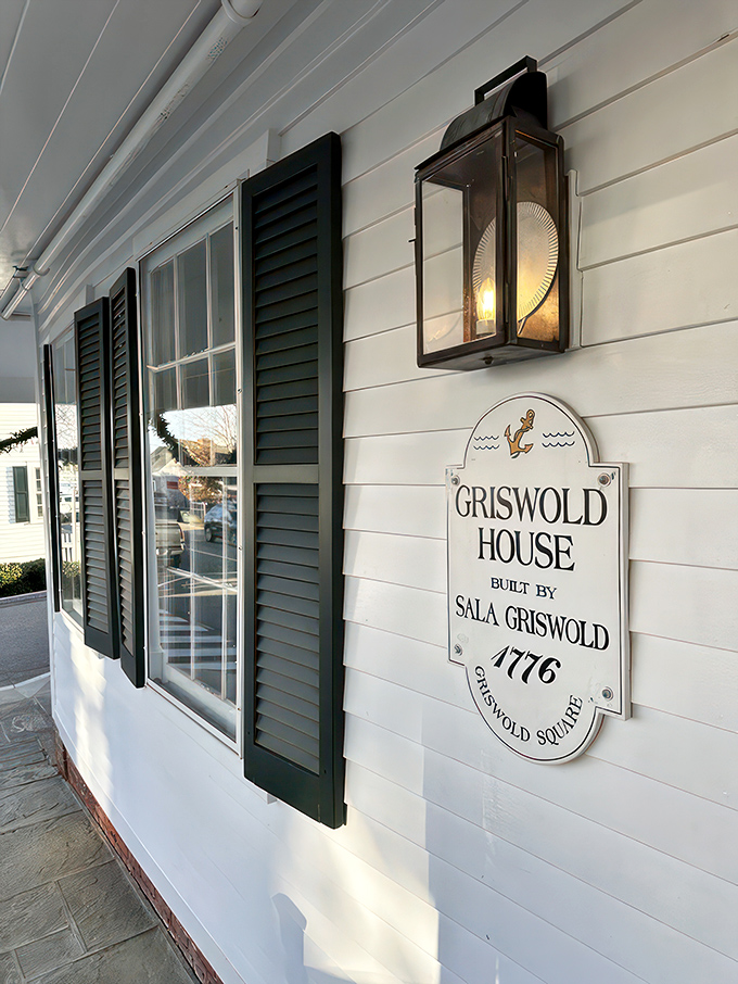 A slice of Americana served with a side of maritime charm. The Griswold Inn's white clapboard exterior whispers tales of centuries past, while the American flag proudly waves hello.