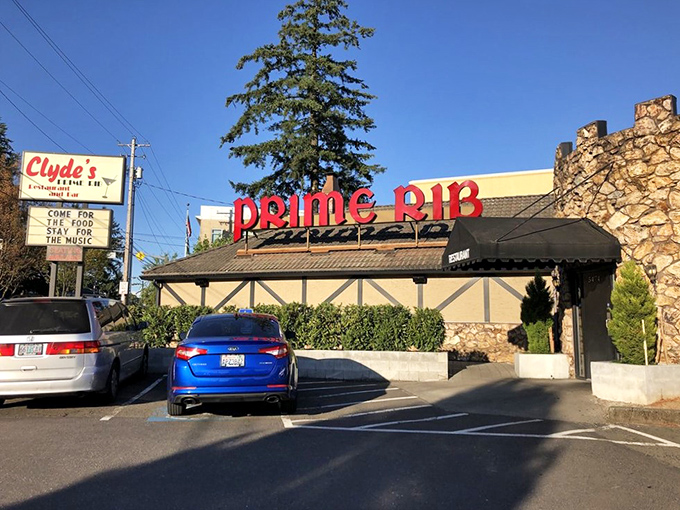A beacon of beefy bliss! Clyde's neon sign promises prime rib paradise, while its Tudor-style exterior whispers of old-world charm.