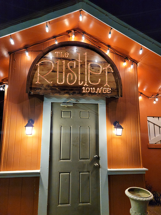 Welcome to The Rustler, where the exterior is as warm and inviting as the prime rib inside. This cozy orange oasis is like a beacon for beef lovers, beckoning you with its twinkling lights and promise of culinary delights.