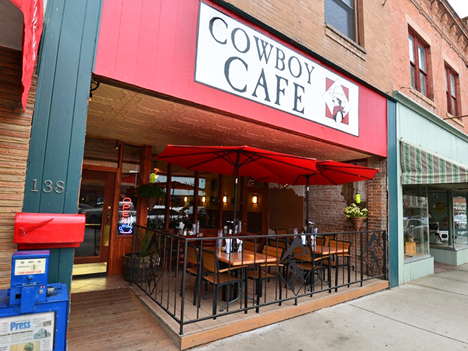 Howdy, partner! The Cowboy Cafe's vibrant red awning is like a beacon for hungry travelers, promising Western hospitality and hearty grub.