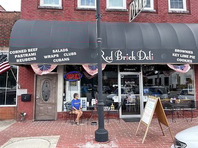 A blue awning announces culinary paradise at Red Brick Deli, where sandwich dreams become delicious reality in downtown Murphy.