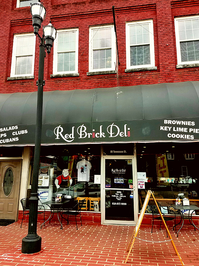 A blue awning announces culinary paradise at Red Brick Deli, where sandwich dreams become delicious reality in downtown Murphy.