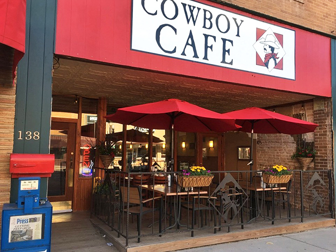 Howdy, partner! The Cowboy Cafe's vibrant red awning is like a beacon for hungry travelers, promising Western hospitality and hearty grub.