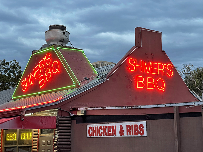 Neon dreams come true! Shiver's BBQ beckons hungry souls with its vibrant sign, promising a smoky paradise that'll make your taste buds dance.
