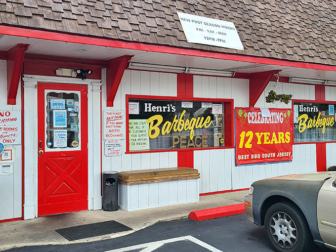 Welcome to barbecue heaven! Henri's Hotts Barbecue stands proud, its red-trimmed exterior promising smoky delights that'll make your taste buds do a happy dance.