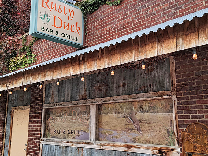Welcome to the Rusty Duck, where the sign may be weathered, but the steaks are always fresh! This unassuming exterior hides a carnivore's paradise within.