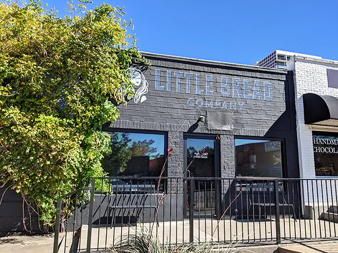 Welcome to carb heaven! Little Bread Company's exterior is like a siren call to bread lovers, with its sleek black facade and eye-catching logo.