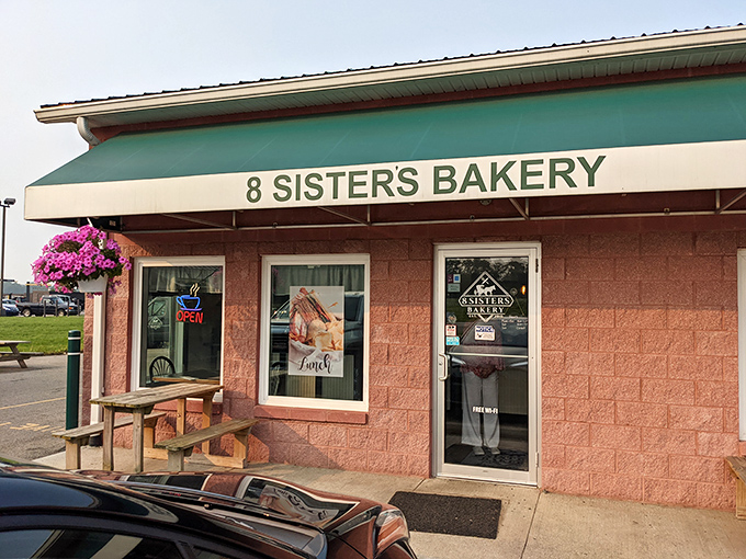 A pink paradise for pastry lovers! 8 Sisters Bakery's charming exterior is like a life-sized dollhouse, complete with a welcoming green awning and vibrant flowers.