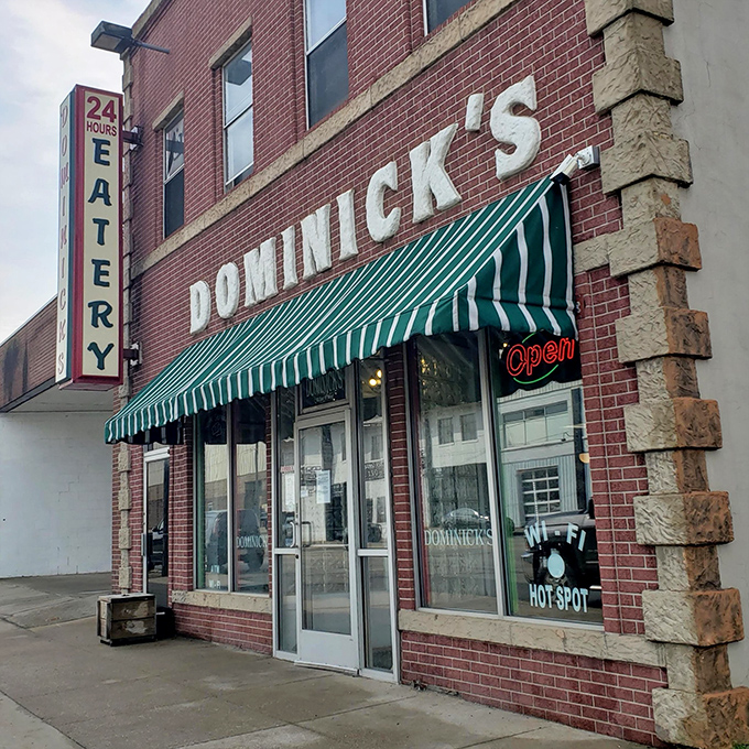 Welcome to Dominick's, where the neon sign beckons like a lighthouse guiding hungry sailors to breakfast nirvana. This brick facade holds more flavor than a spice rack convention.