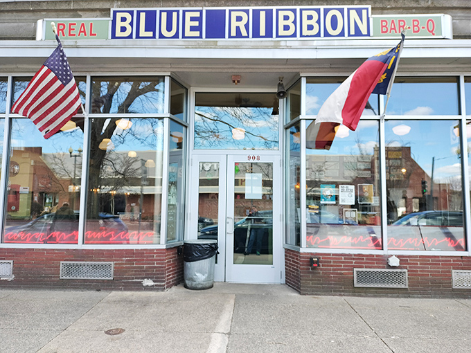A beacon of barbecue bliss! Blue Ribbon's storefront promises smoky delights, with outdoor seating perfect for savoring summer and sauce-stained fingers. 