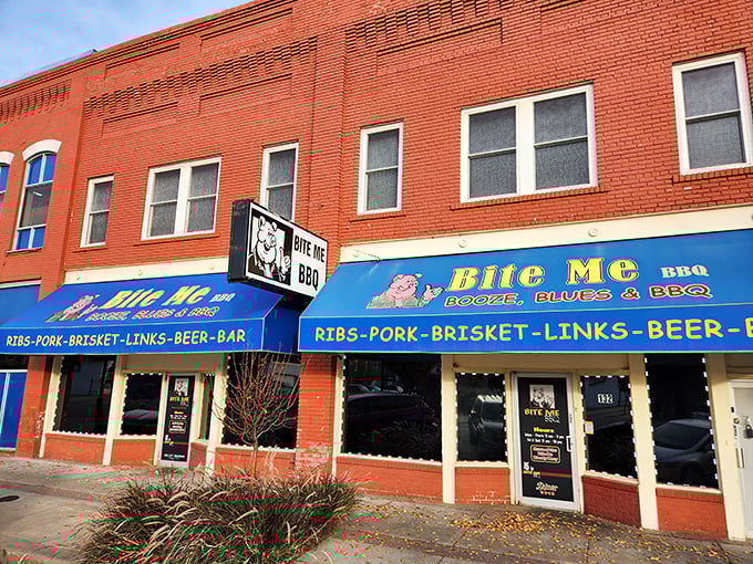 Welcome to flavor town! Bite Me BBQ's exterior promises a smoky paradise, with blue awnings that scream "meat lovers, your dream awaits!"