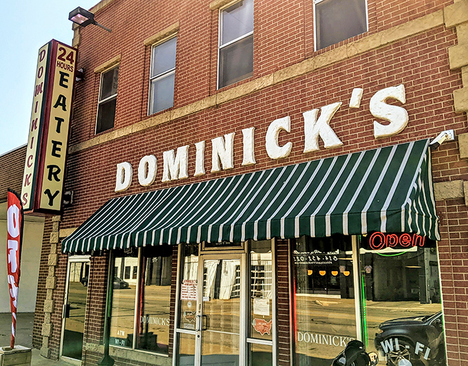 Welcome to Dominick's, where the neon sign beckons like a lighthouse guiding hungry sailors to breakfast nirvana. This brick facade holds more flavor than a spice rack convention.