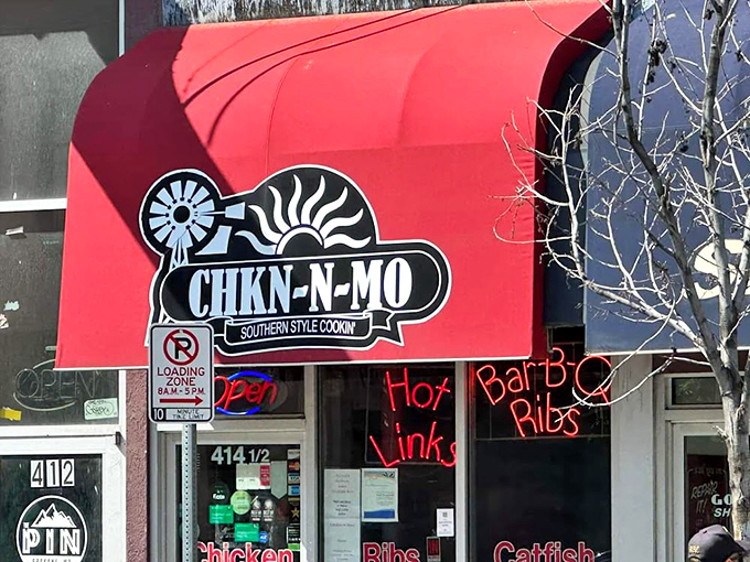 Welcome to flavor town! This vibrant red awning is like a beacon for barbecue lovers, promising Southern-style cookin' that'll make your taste buds dance.
