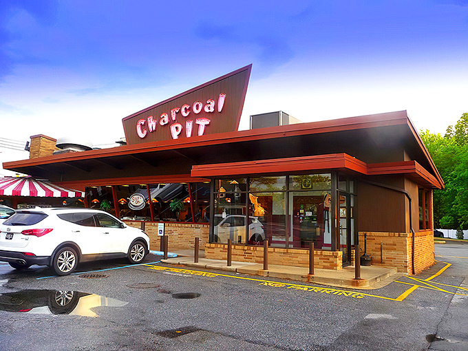Welcome to the Charcoal Pit, where the 1950s never left and your diet goes on vacation! This retro wonderland serves up nostalgia with a side of neon-lit charm.