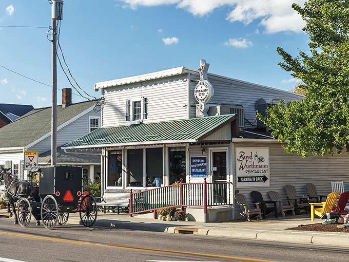 The white clapboard exterior of Boyd & Wurthmann stands as a time capsule in Berlin, where Amish buggies park alongside modern vehicles in perfect small-town harmony.