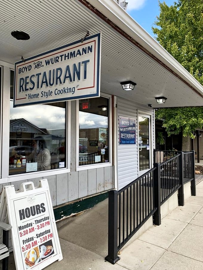 The white clapboard exterior of Boyd & Wurthmann stands as a time capsule in Berlin, where Amish buggies park alongside modern vehicles in perfect small-town harmony.