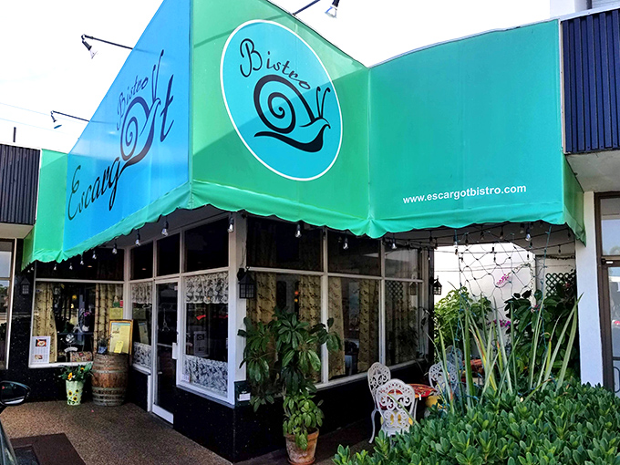 A slice of Paris in the Sunshine State! Escargot Bistro's vibrant awning beckons like a Gallic lighthouse in a sea of palm trees.