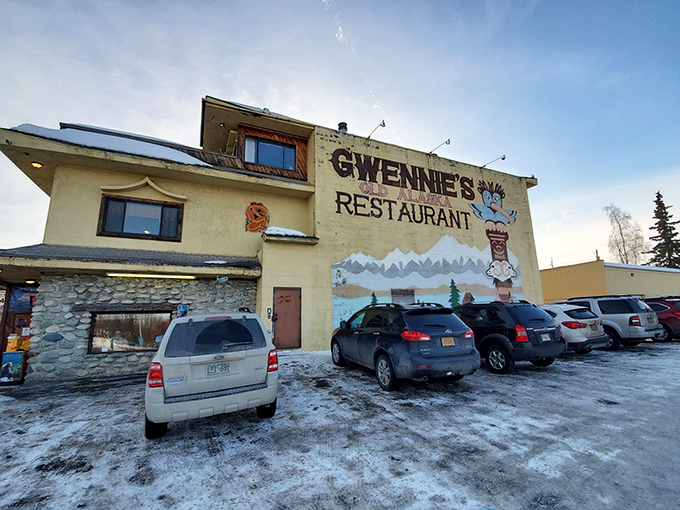 The pale yellow exterior of Gwennie's stands like a cheerful sentinel against Alaska's often-gray skies, complete with iconic totem pole mural.