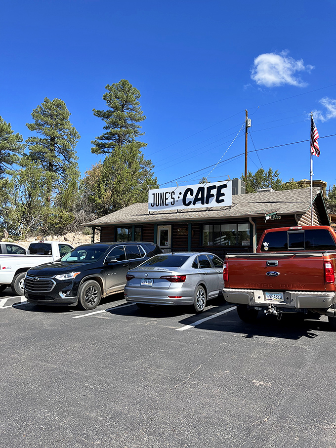 The log cabin charm of June's Cafe stands proudly against Arizona's blue sky, complete with American flag &ndash; a beacon of breakfast hope for hungry travelers.