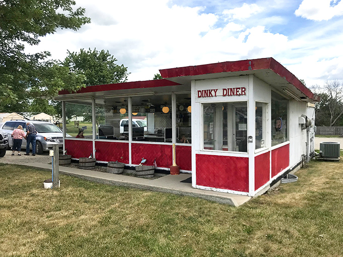 A slice of Americana, served with a side of nostalgia! This little red-and-white diner looks like it jumped straight out of a Norman Rockwell painting.